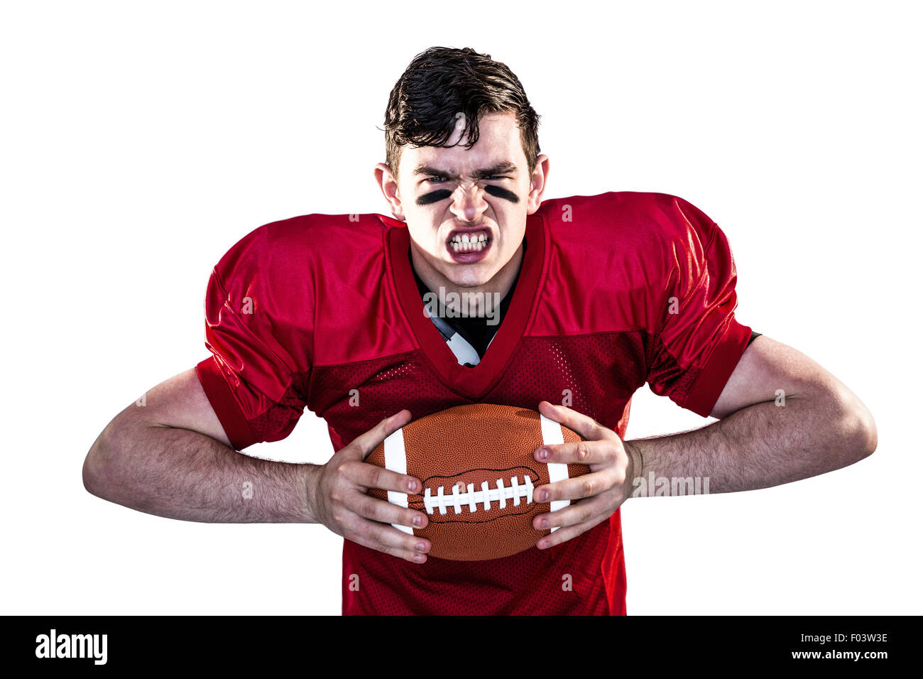 American football player crushing a ball Stock Photo - Alamy