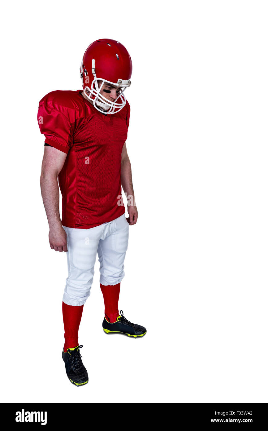 Unsmiling american football player looking down Stock Photo - Alamy