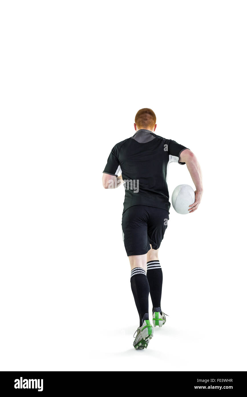Rugby player running with a rugby ball Stock Photo - Alamy