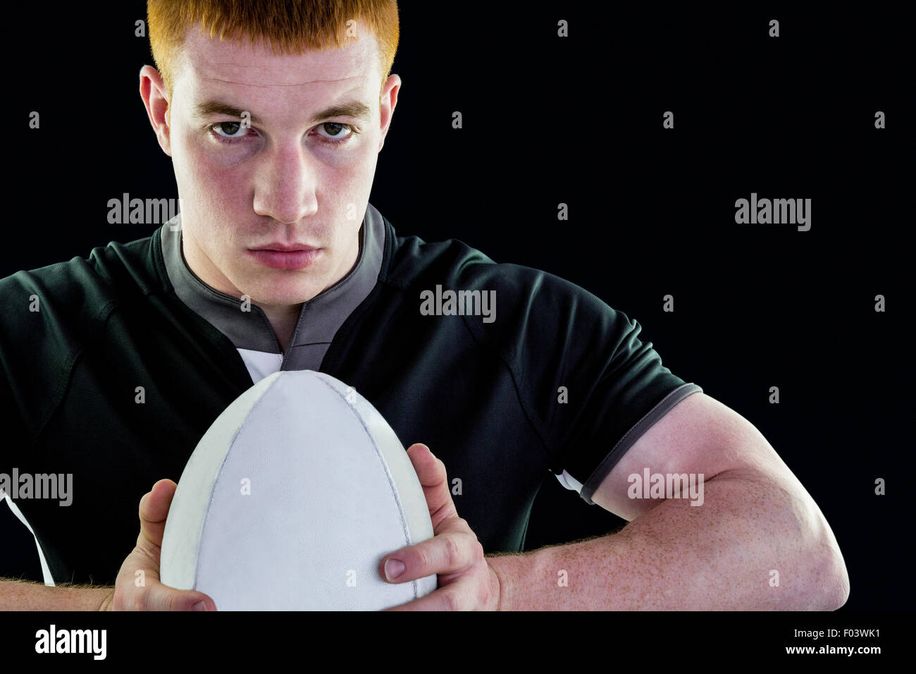 Rugby player holding a rugby ball Stock Photo - Alamy