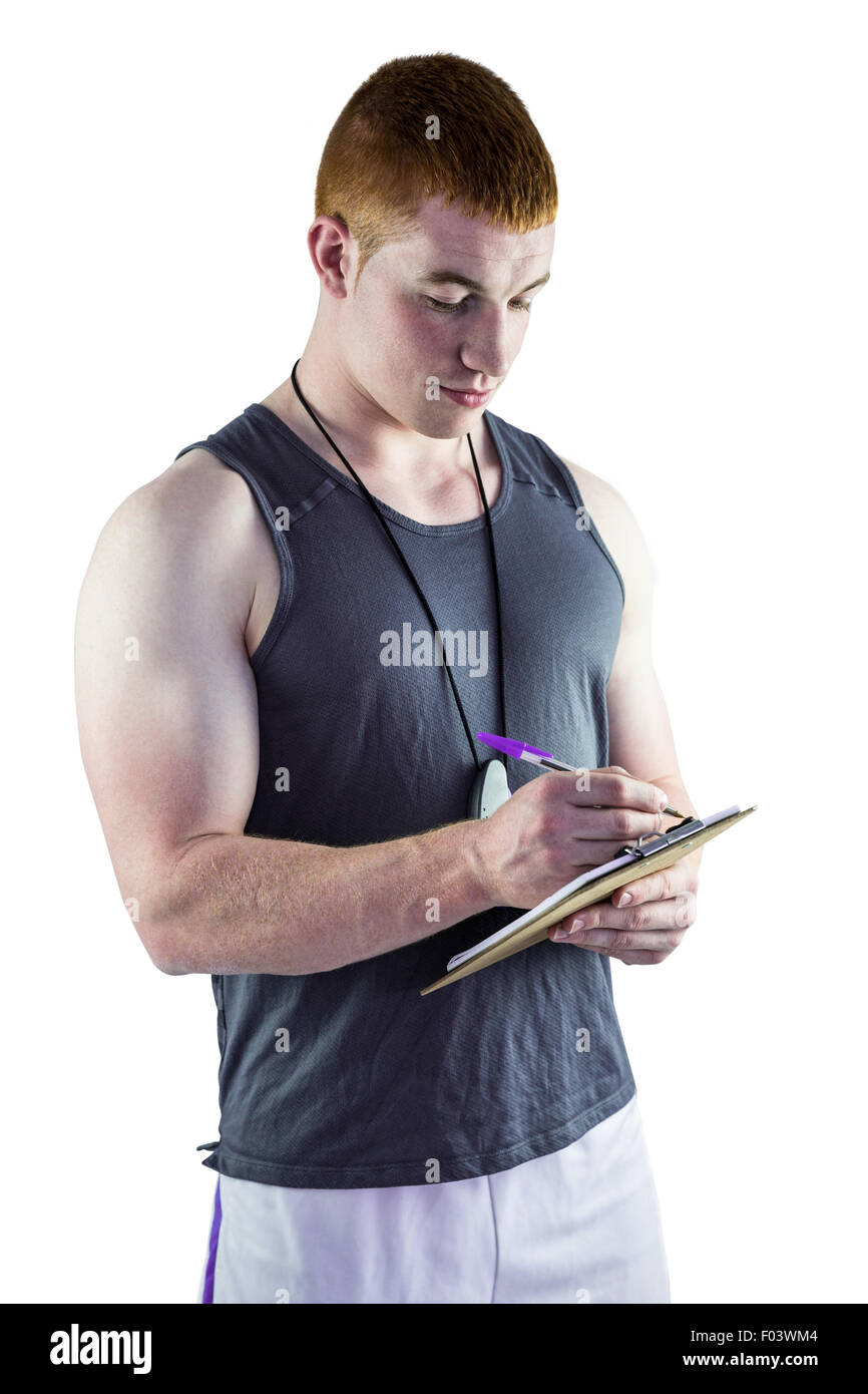Fit personal trainer writing on clipboard Stock Photo - Alamy