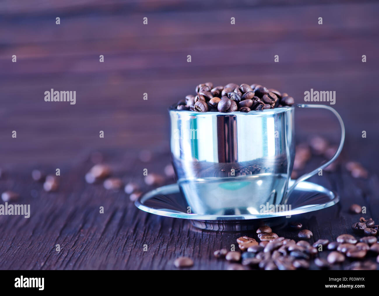 coffee beans in metal cup and on a table Stock Photo - Alamy