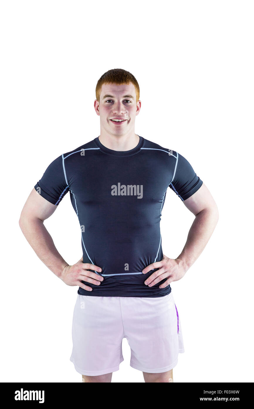 Smiling rugby player with hands on hips Stock Photo - Alamy