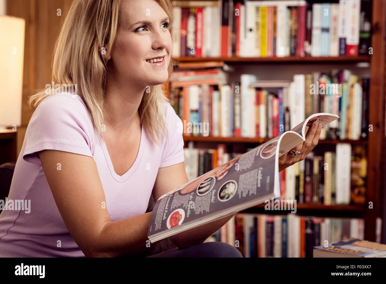 Woman reading at home Stock Photo - Alamy