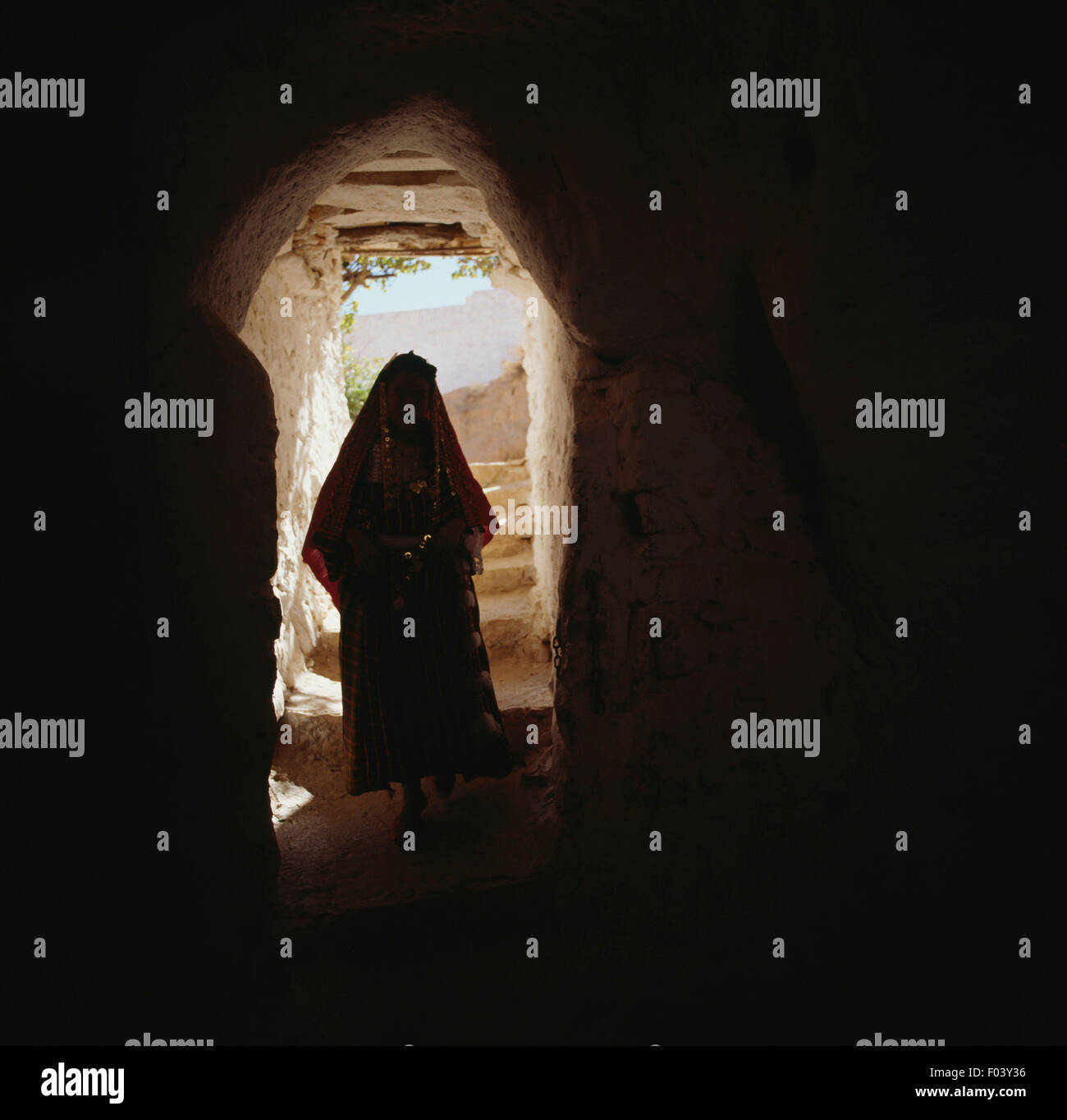 Backlit Berber girl in traditional clothes, Matmata, Tunisia Stock ...