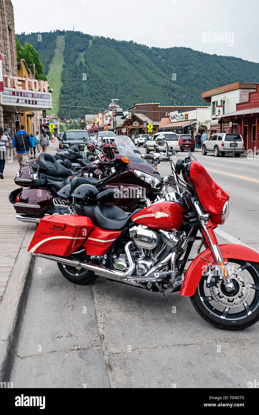 vertical image of modern motorcycle on the street of old West city ...