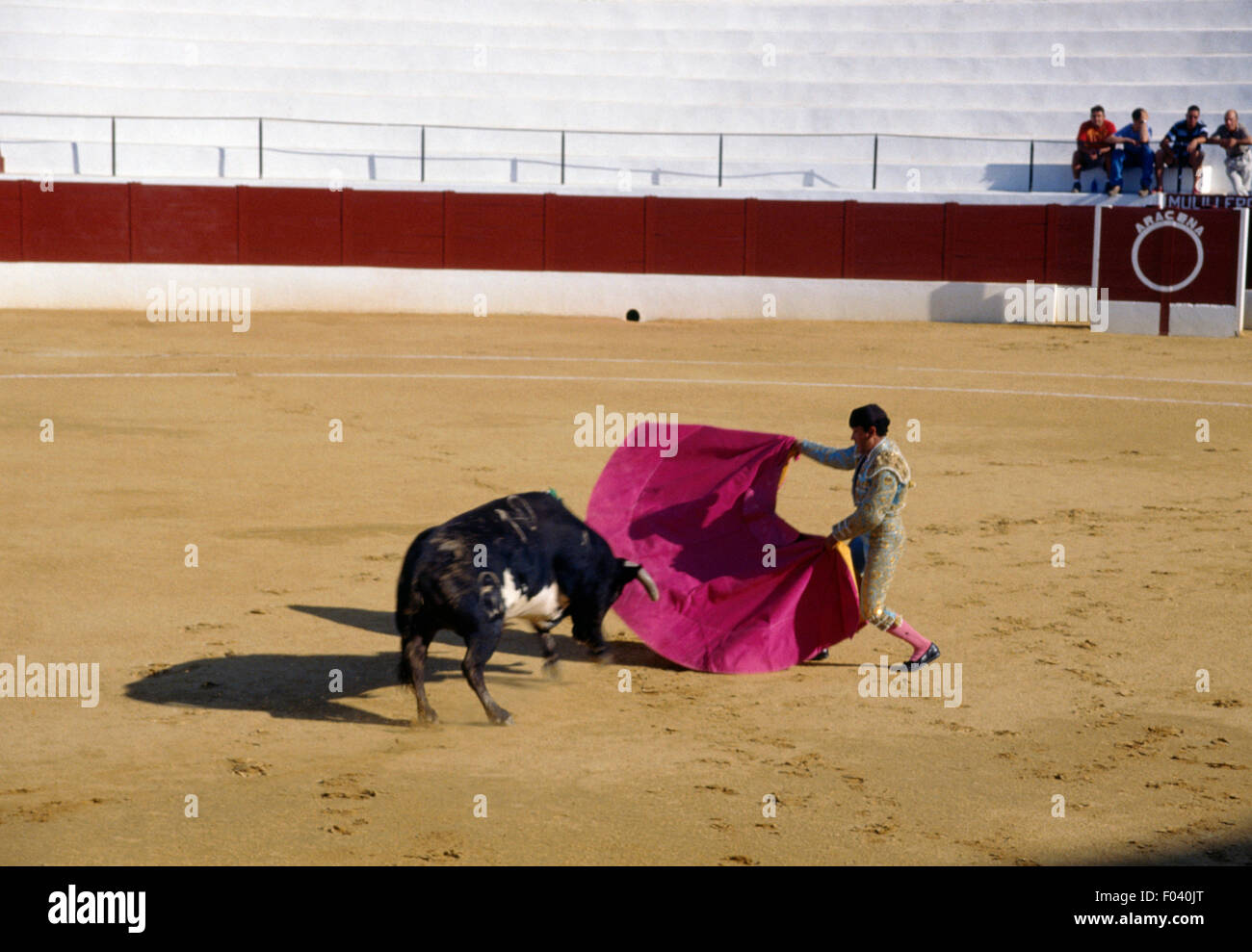 Bullfighter in action during a bullfight using the cape, Aracena ...