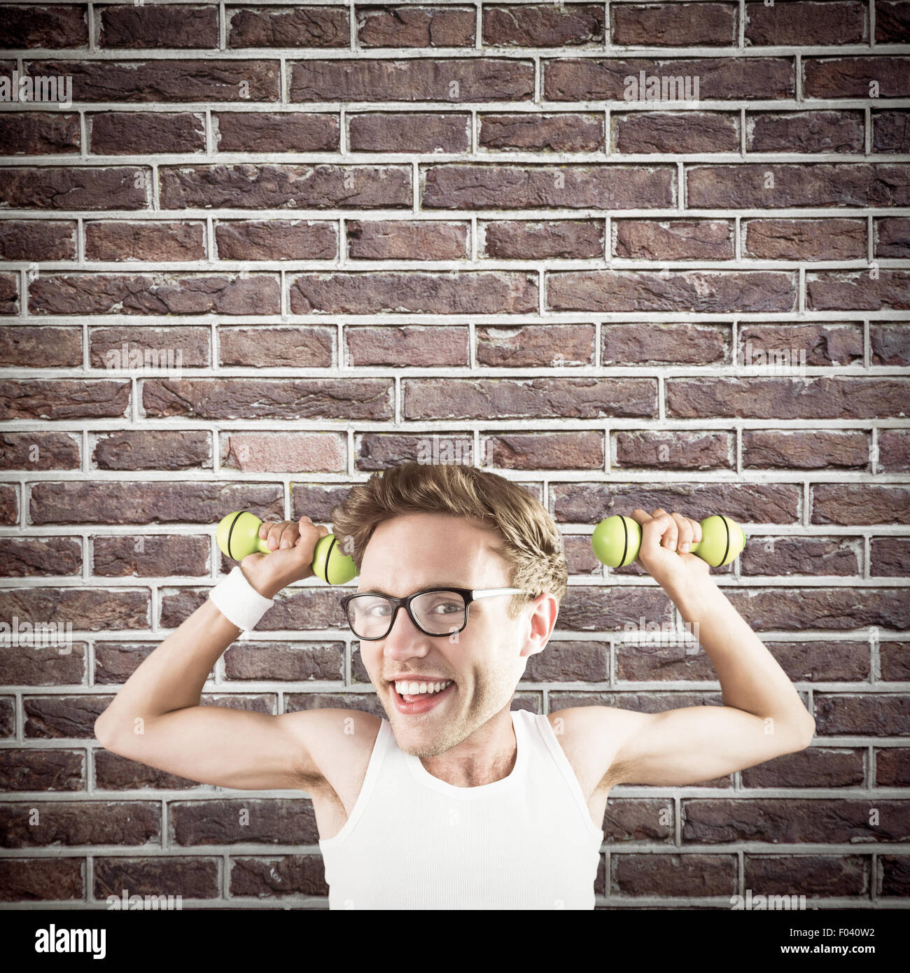 Composite image of nerd lifting weights Stock Photo - Alamy