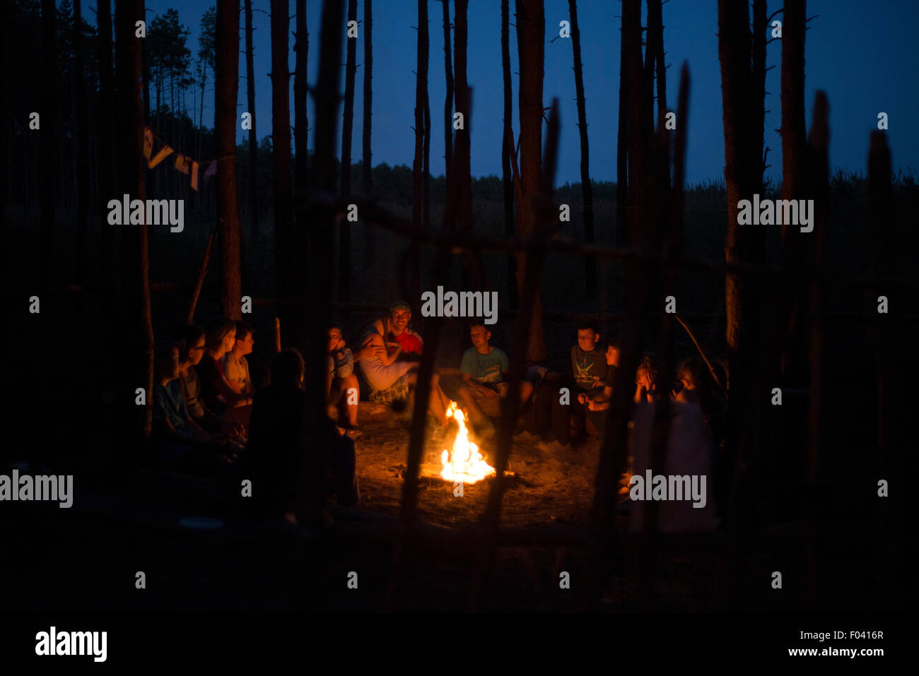 Scouts sitting at a campfire in Ukrainian scout training camp, Kiev ...
