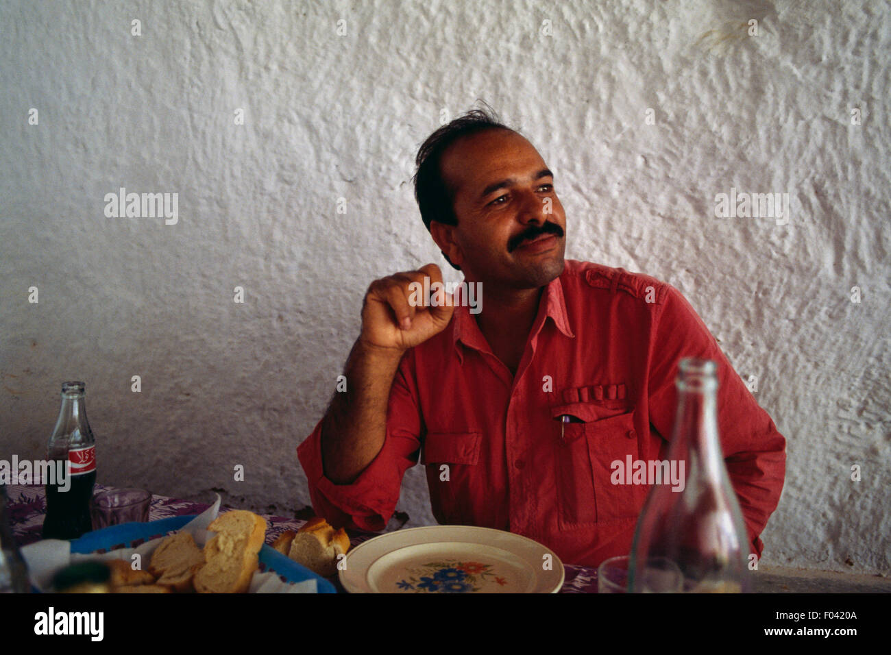 Man sitting at a table, Matmata Berber festival, Tunisia Stock Photo ...