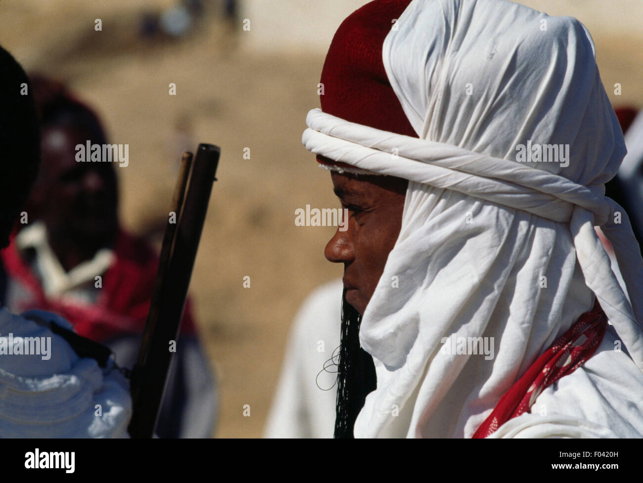Man in traditional dress holding a gun, Matmata Berber festival ...