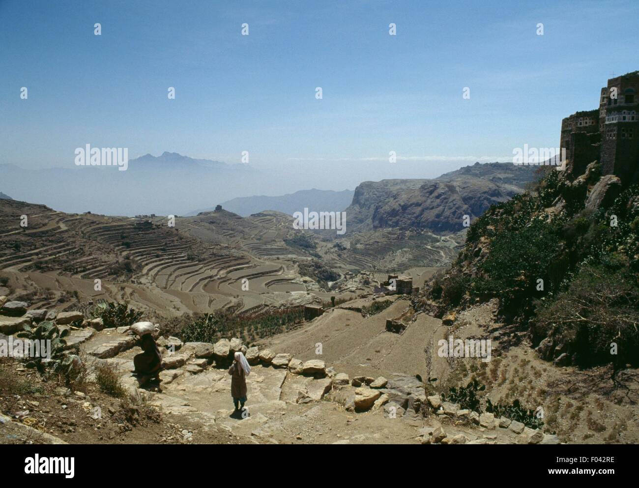 Women down a mule track with terraced fields in the background, Al ...