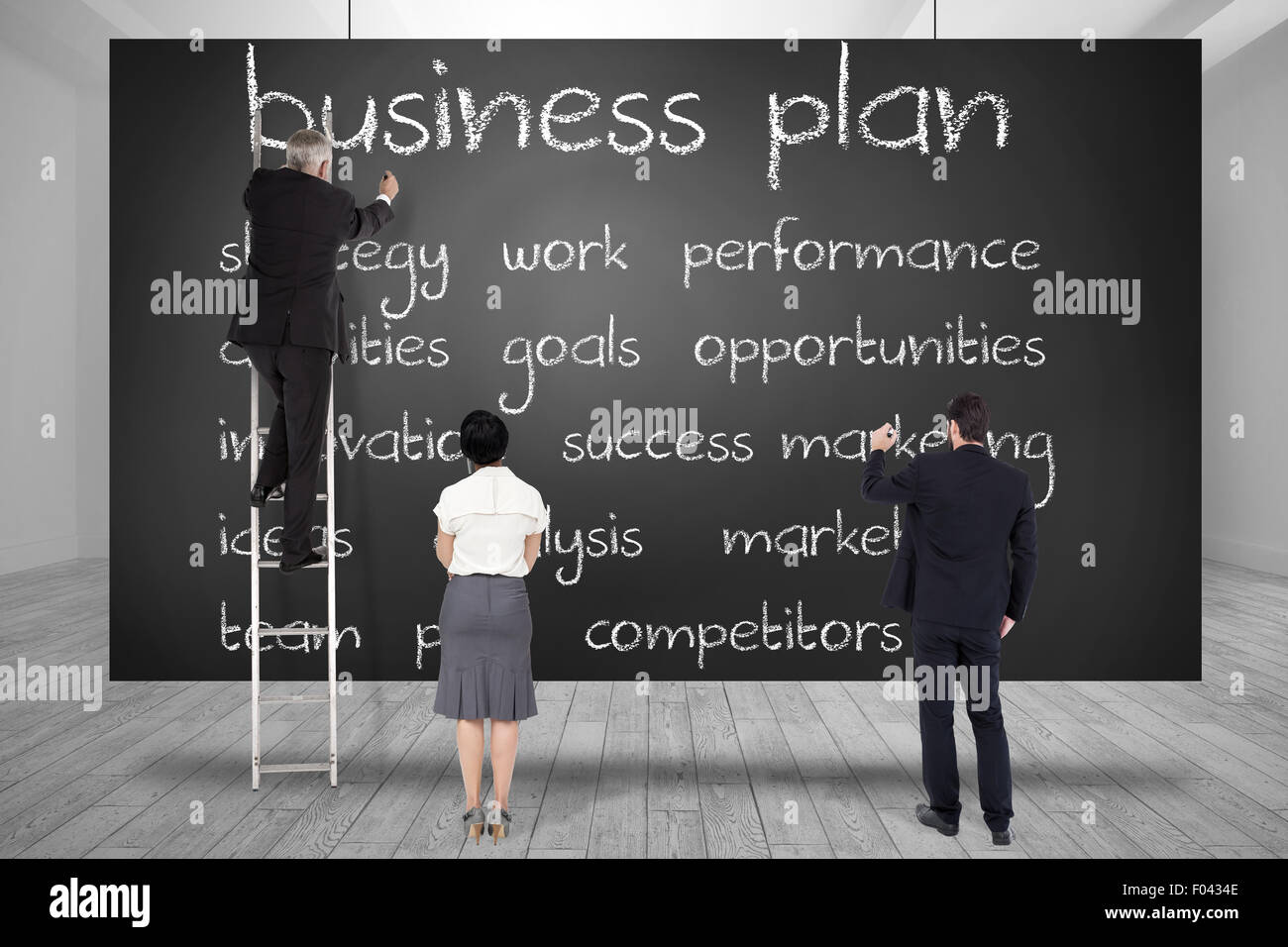 Composite image of business team writing Stock Photo - Alamy