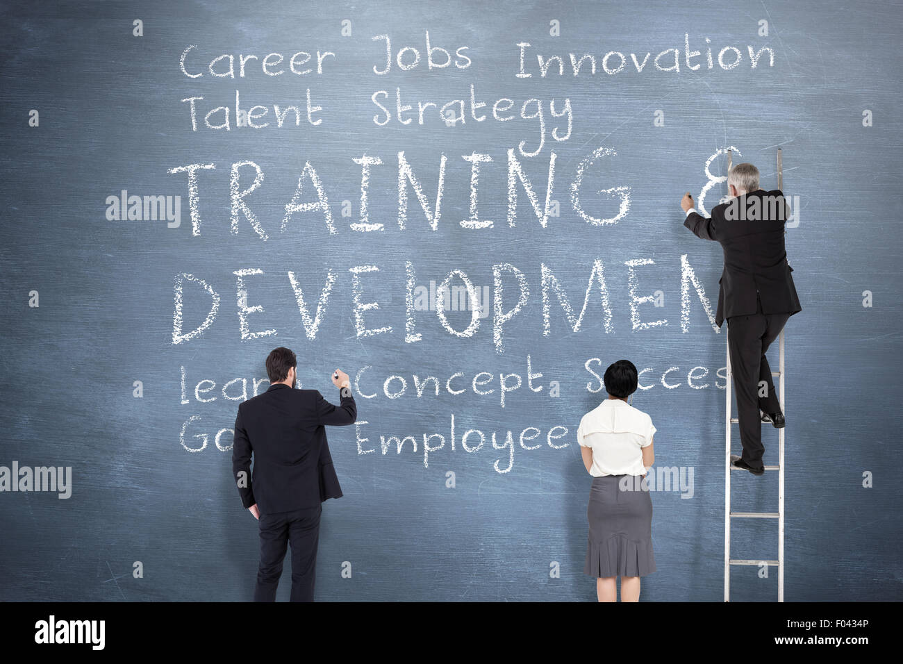 Composite image of business team writing Stock Photo - Alamy