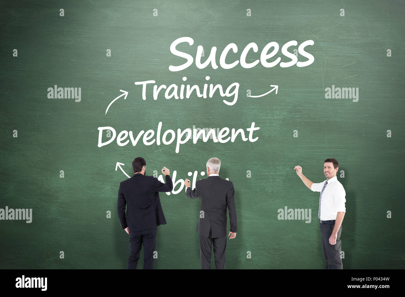 Composite image of business team writing Stock Photo - Alamy