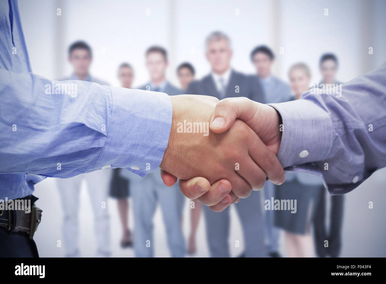Composite image of two men shaking hands Stock Photo - Alamy