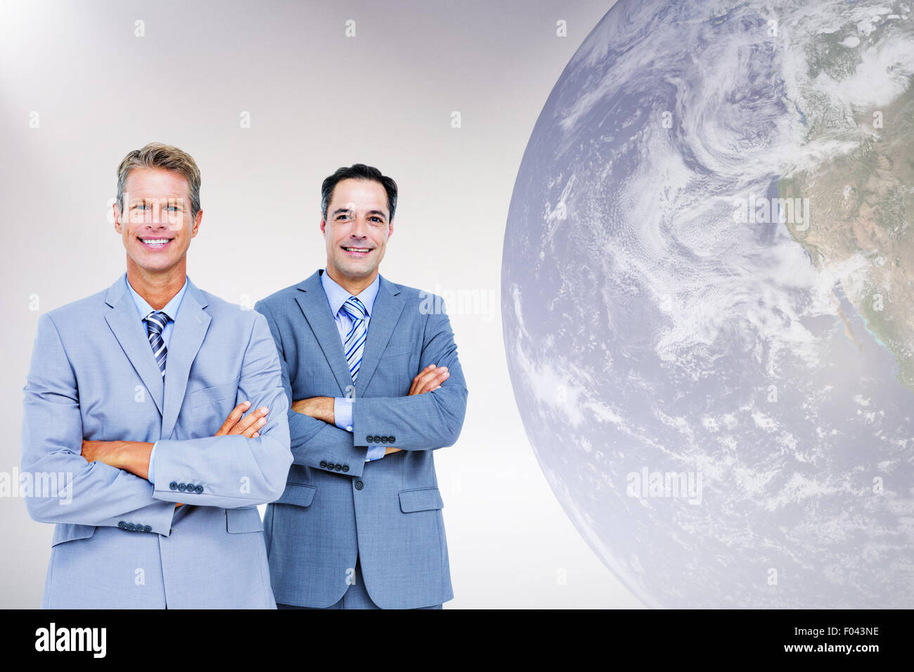 Composite image of business team standing arms crossed Stock Photo - Alamy
