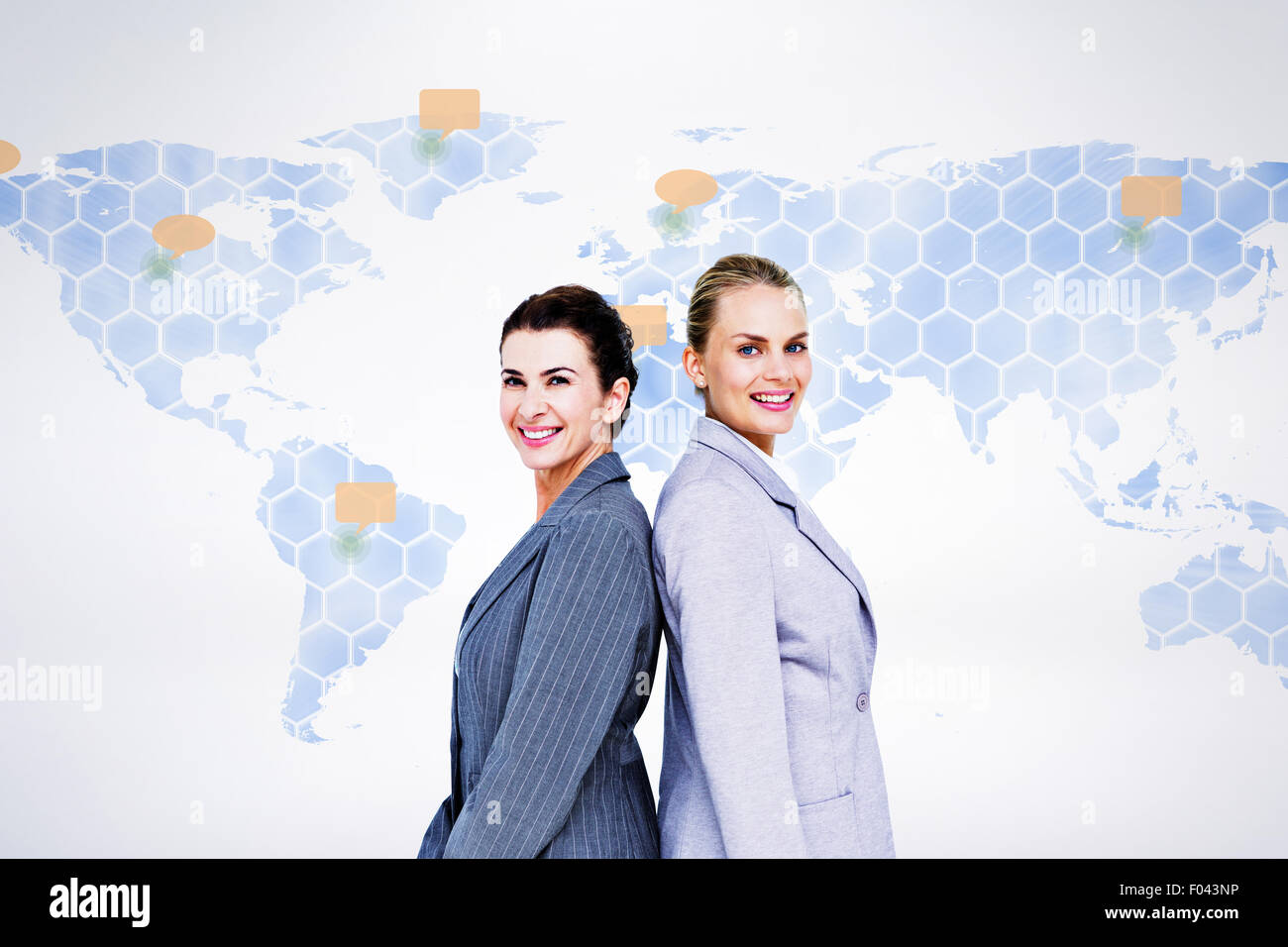 Composite image of attractive businesswomen standing back-to-back Stock ...