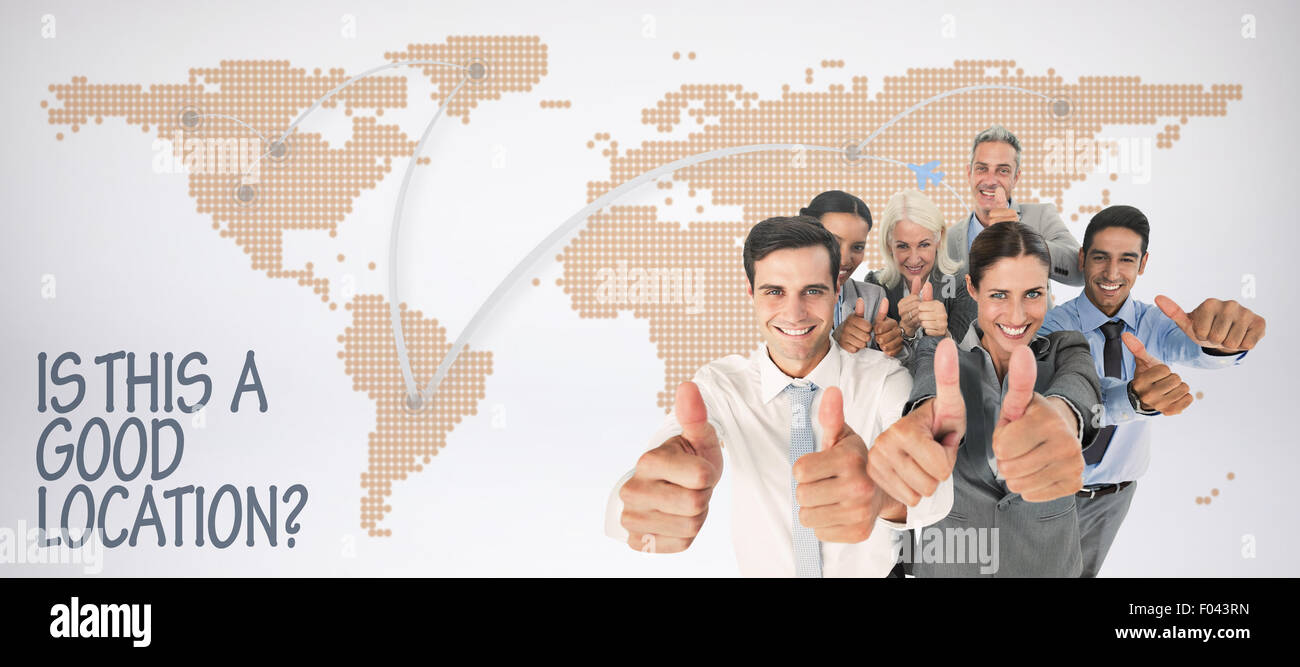 Composite image of happy business people looking at camera with thumbs ...