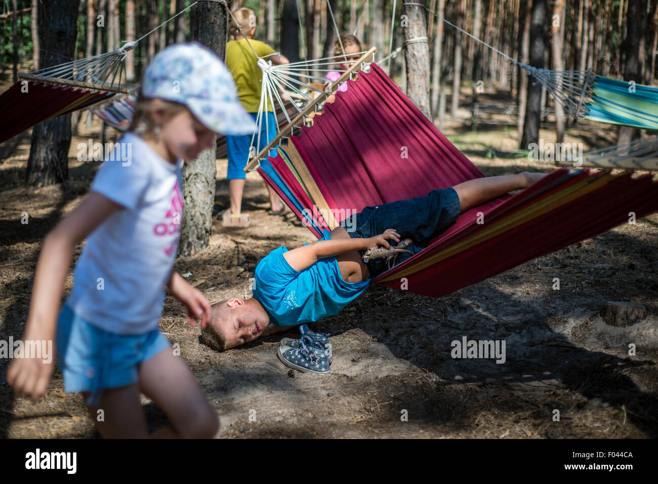 Children playing on hammocks Ukrainian scout training camp, Kiev region ...