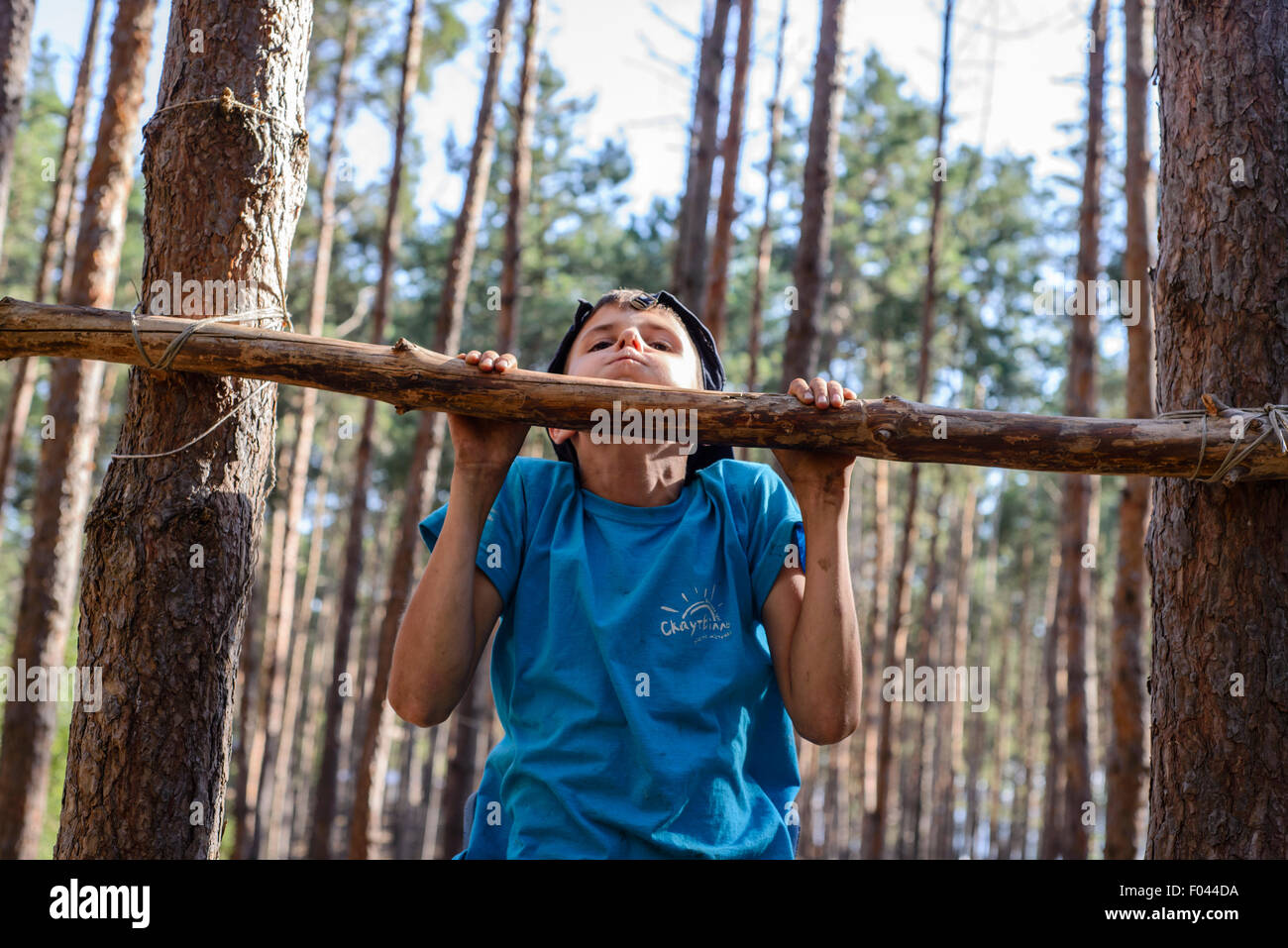Boy scout on the horizontal bar in Ukrainian scout training camp, Kiev ...