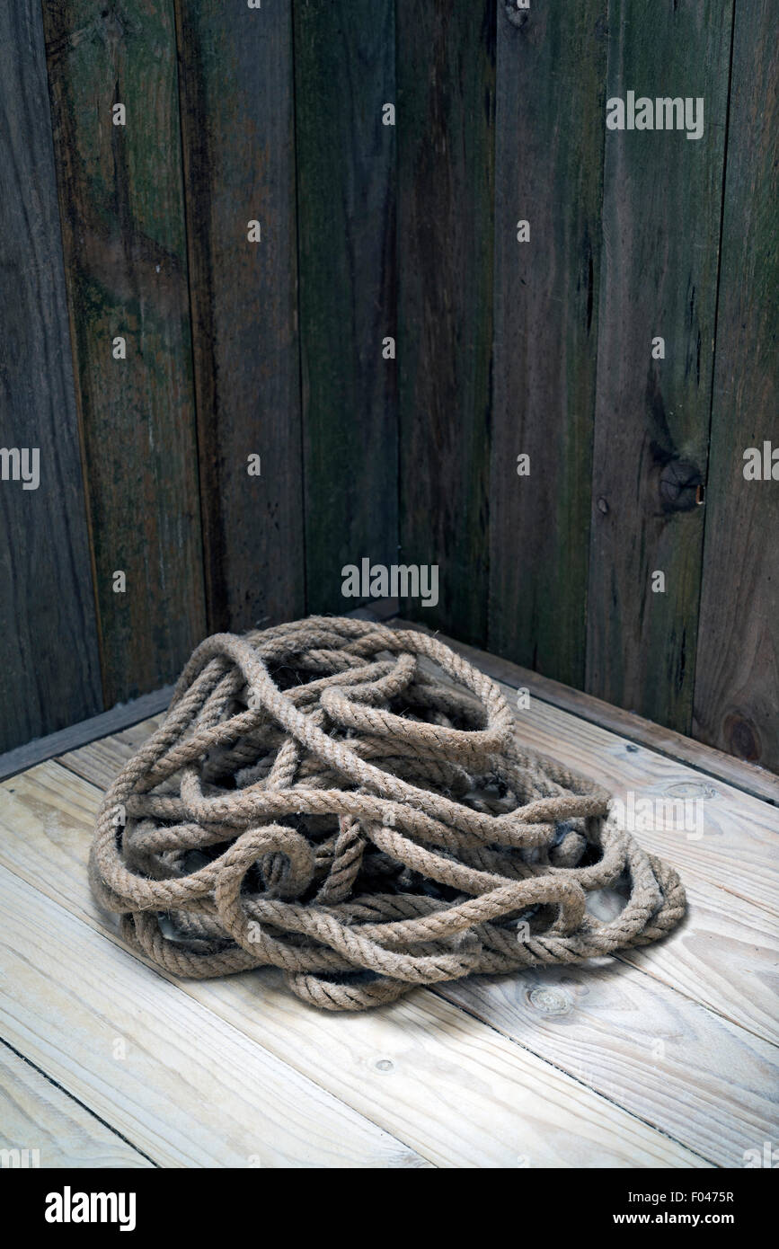 plenty of rope tangled on a wooden shelf Stock Photo - Alamy