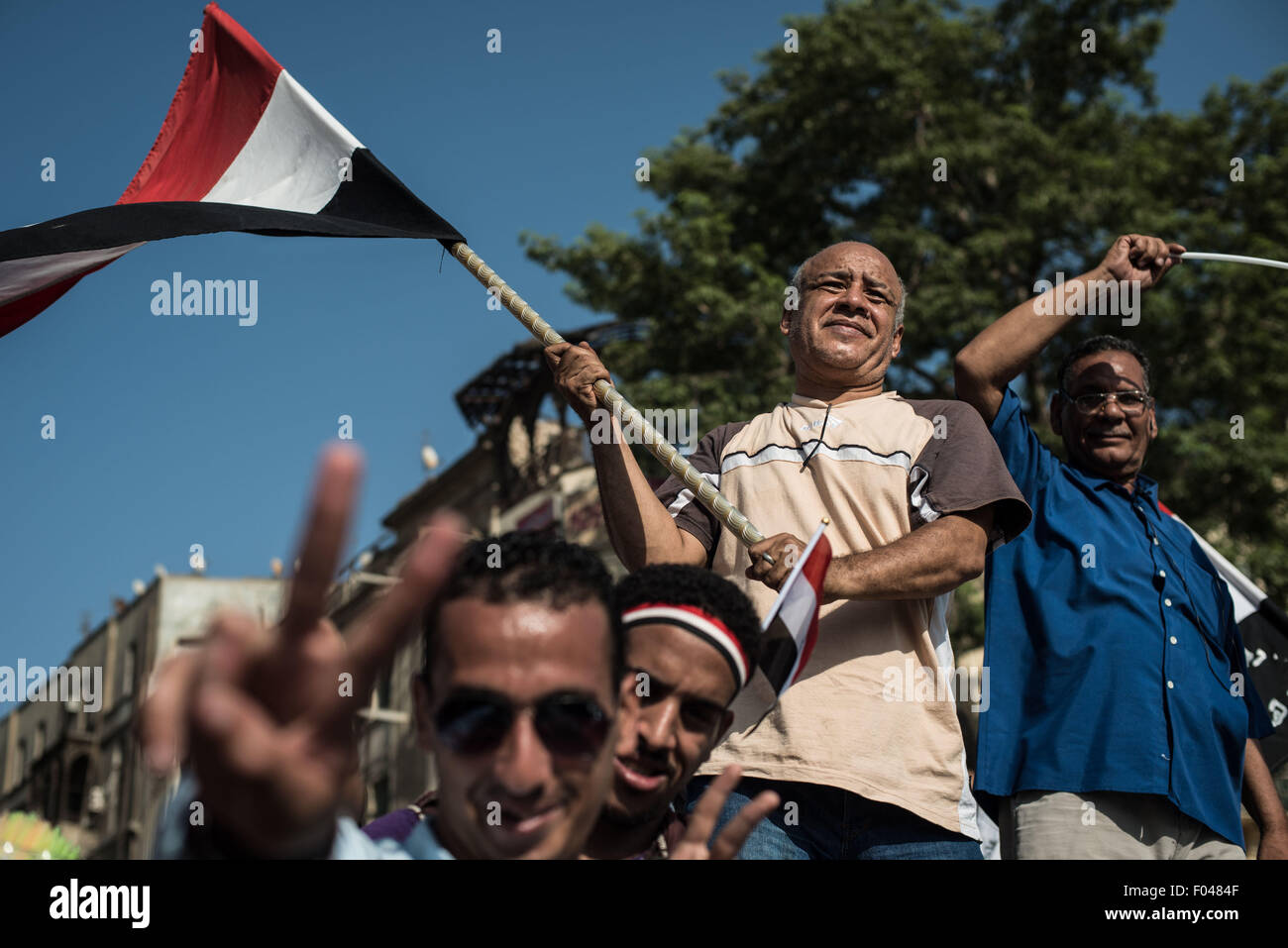Cairo, Egypt. 6th Aug, 2015. Egyptians wave their national flags as ...