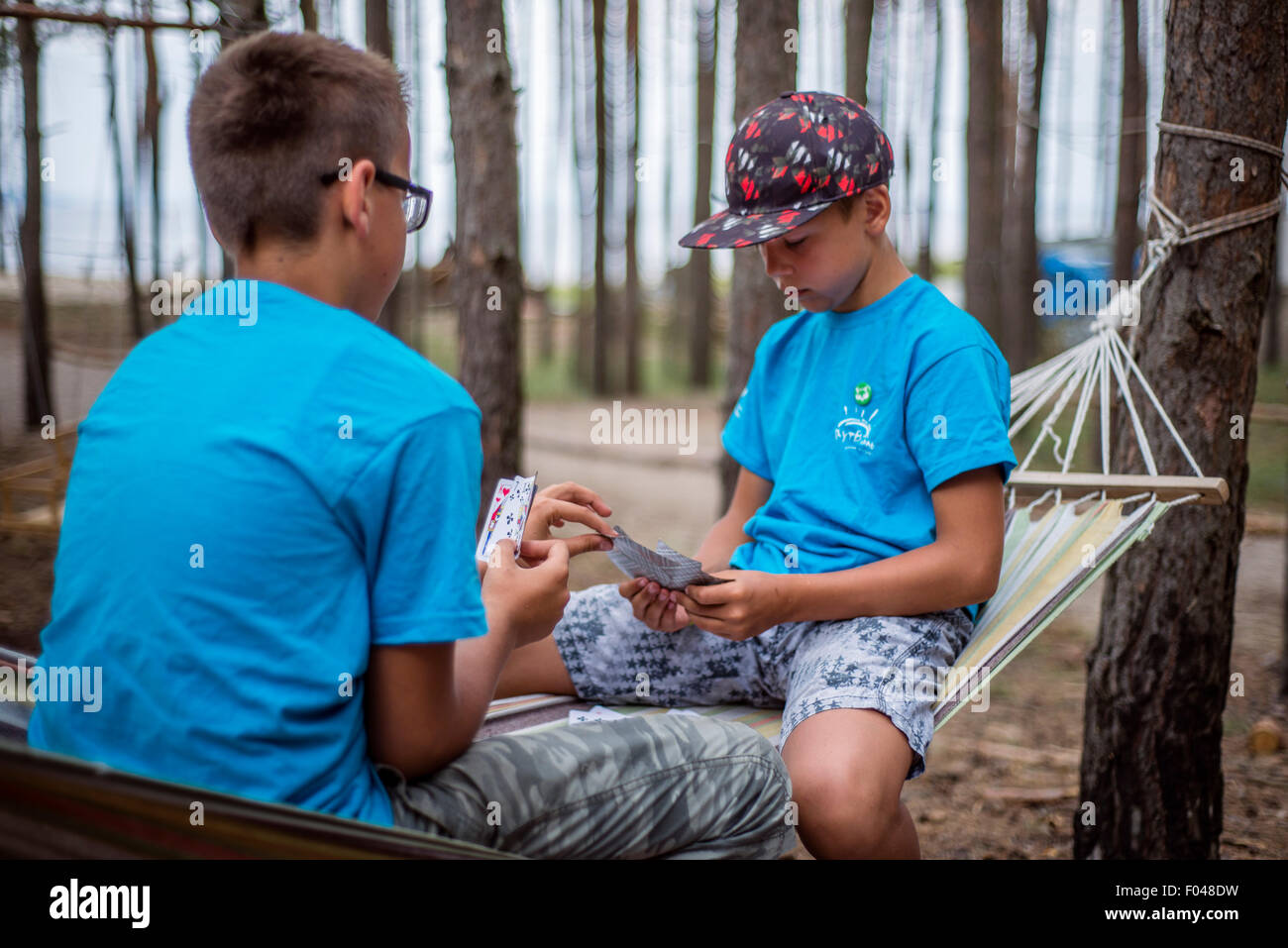 Boy scouts playing cards in Ukrainian scout training camp, Kiev region ...