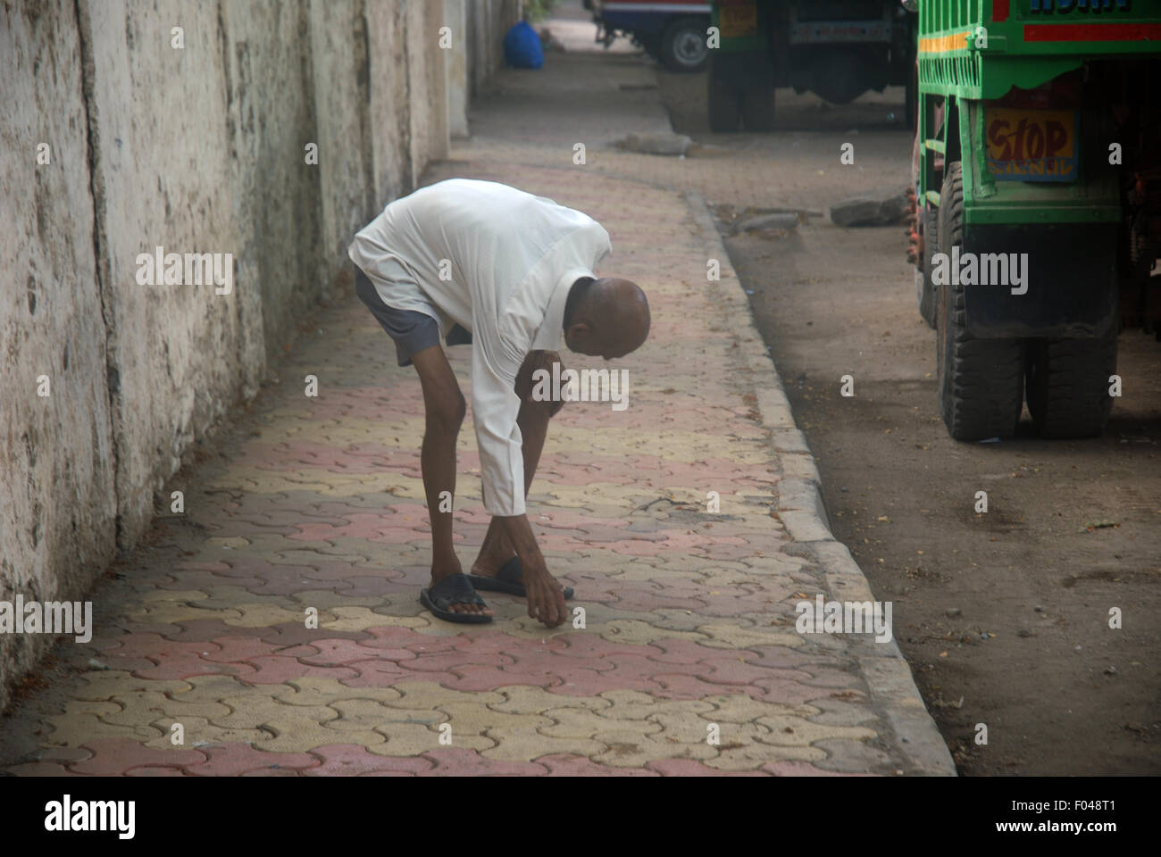 Old man walking alone on street, Mumbai, India Stock Photo - Alamy