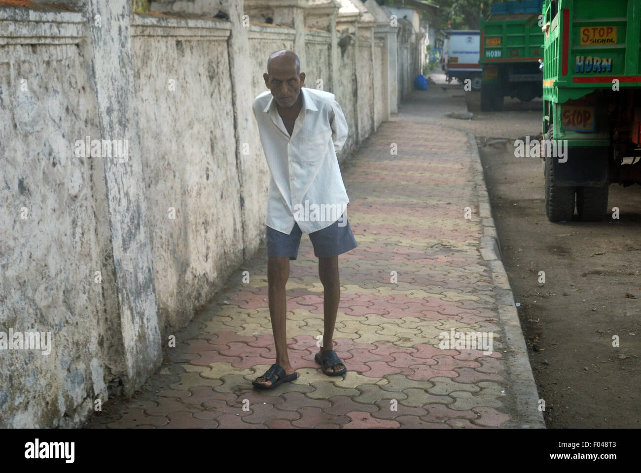 Old man walking alone on street, Mumbai, India Stock Photo - Alamy