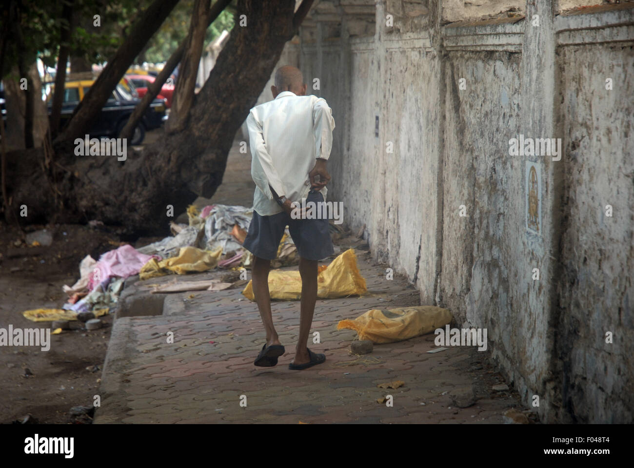 Old man walking alone on street, Mumbai, India Stock Photo - Alamy