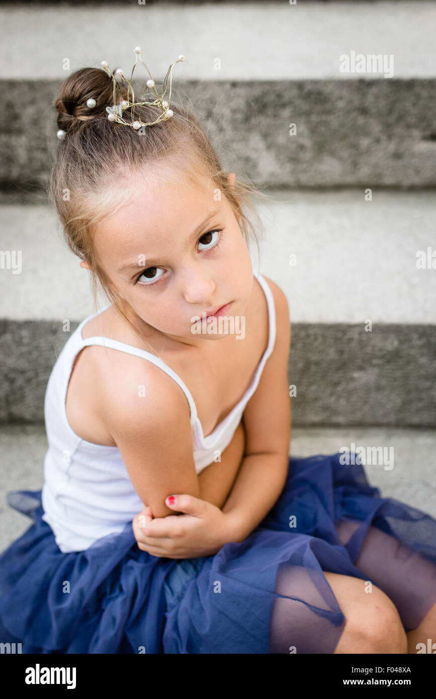 sad / bored / angry little princess with golden crown on her head ...