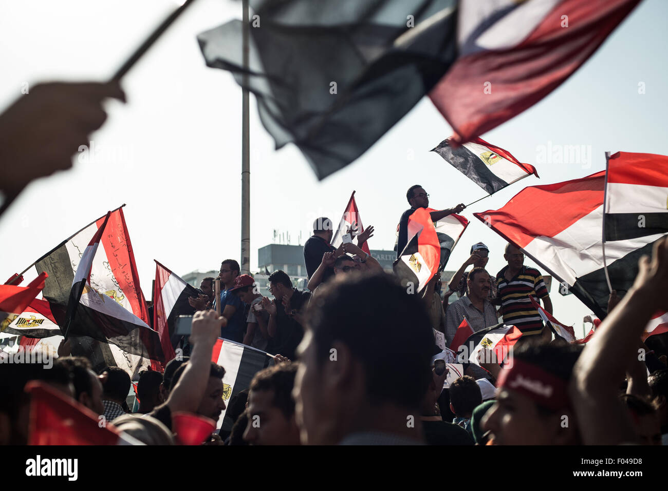 Cairo, Egypt. 6th Aug, 2015. Egyptians wave their national flags as ...