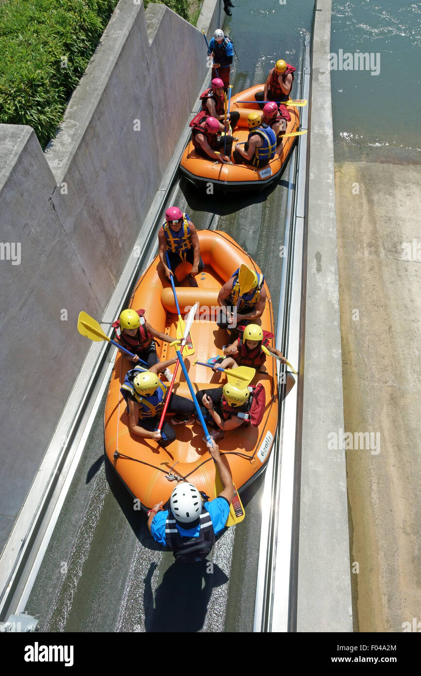 Rafts on conveyor belt lift at artificial white water sports centre in ...