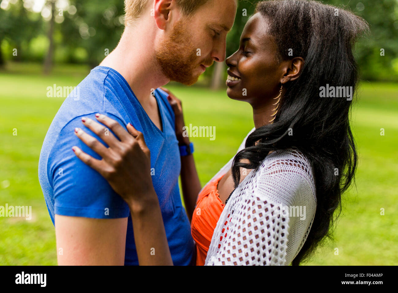 Multiracial couple in the park Stock Photo - Alamy