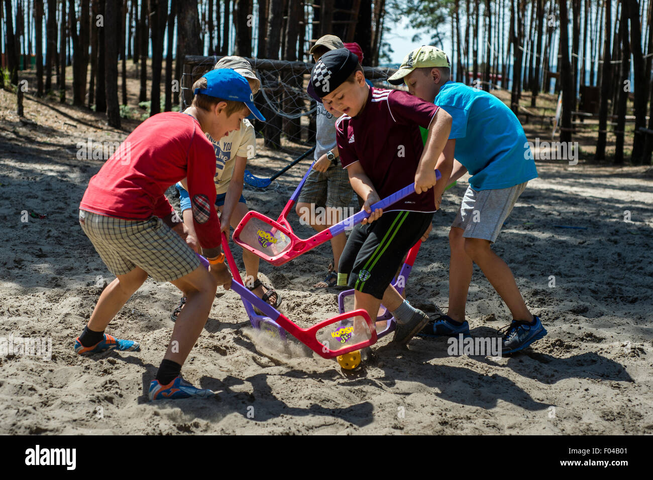 Boy scouts playing floorball match in Ukrainian scout training camp ...