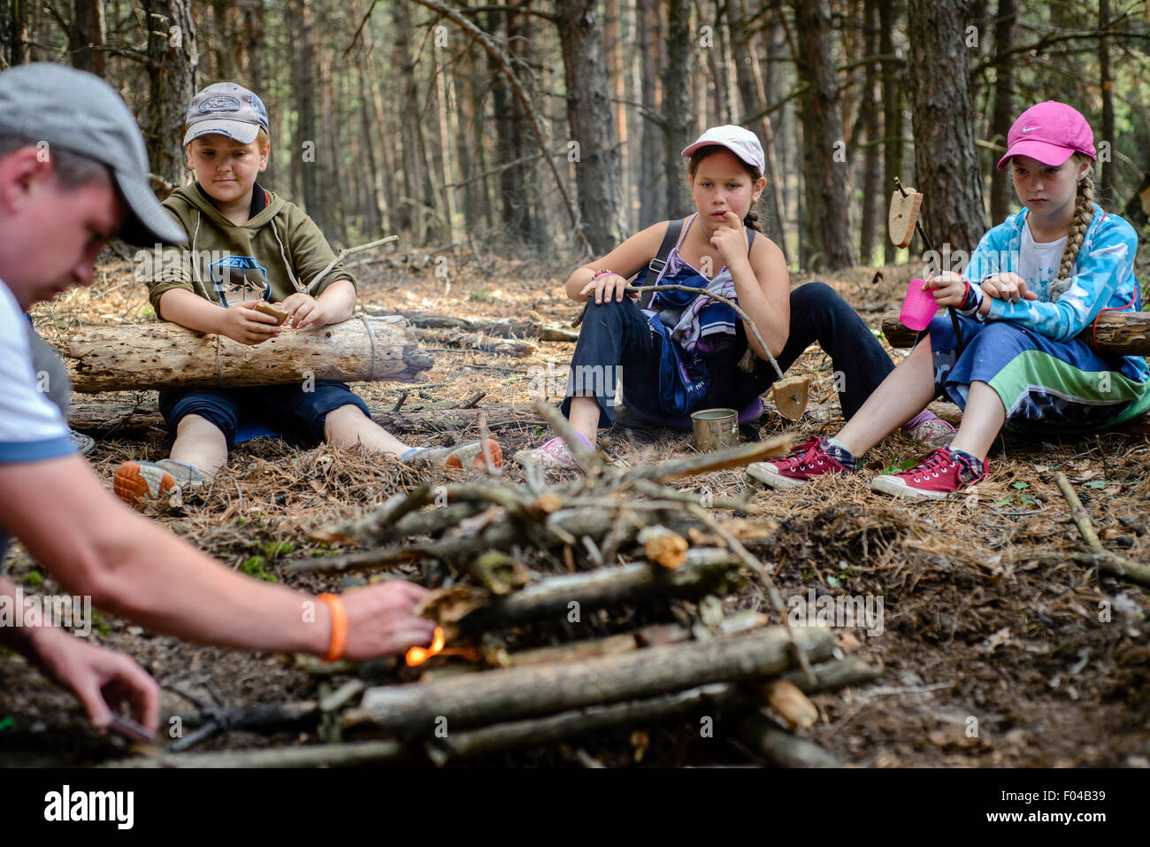 Scouts roasting bread over campfire in a hike, Ukrainian scout training ...