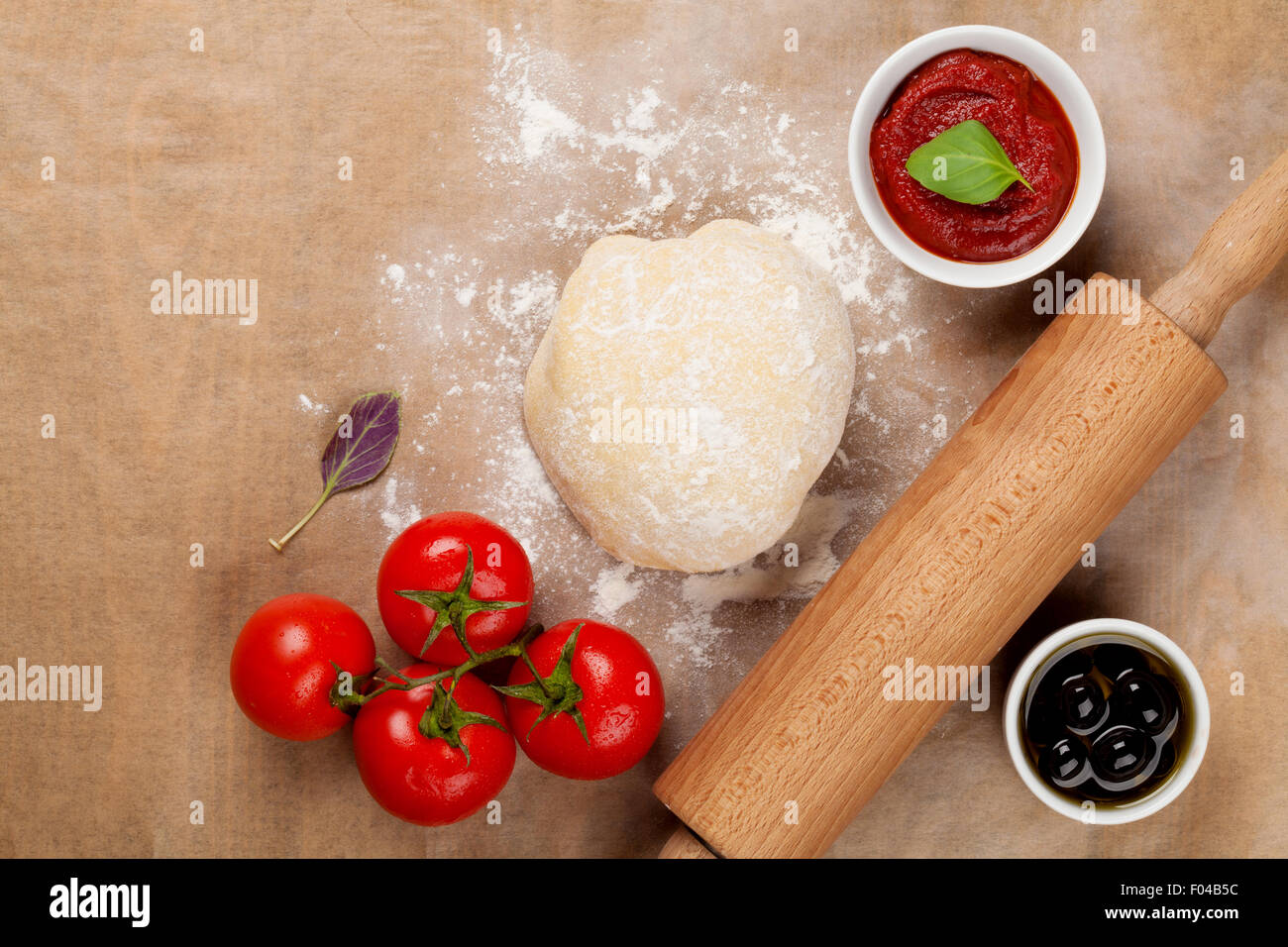 Pizza cooking ingredients. Dough, vegetables and spices. Top view with ...
