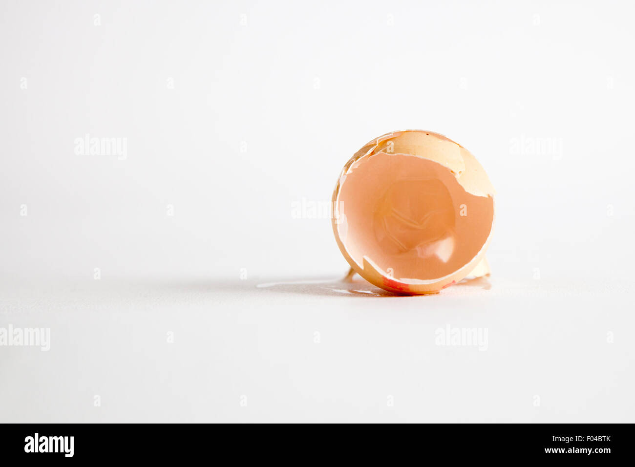 Cracked and empty egg on a white background Stock Photo - Alamy