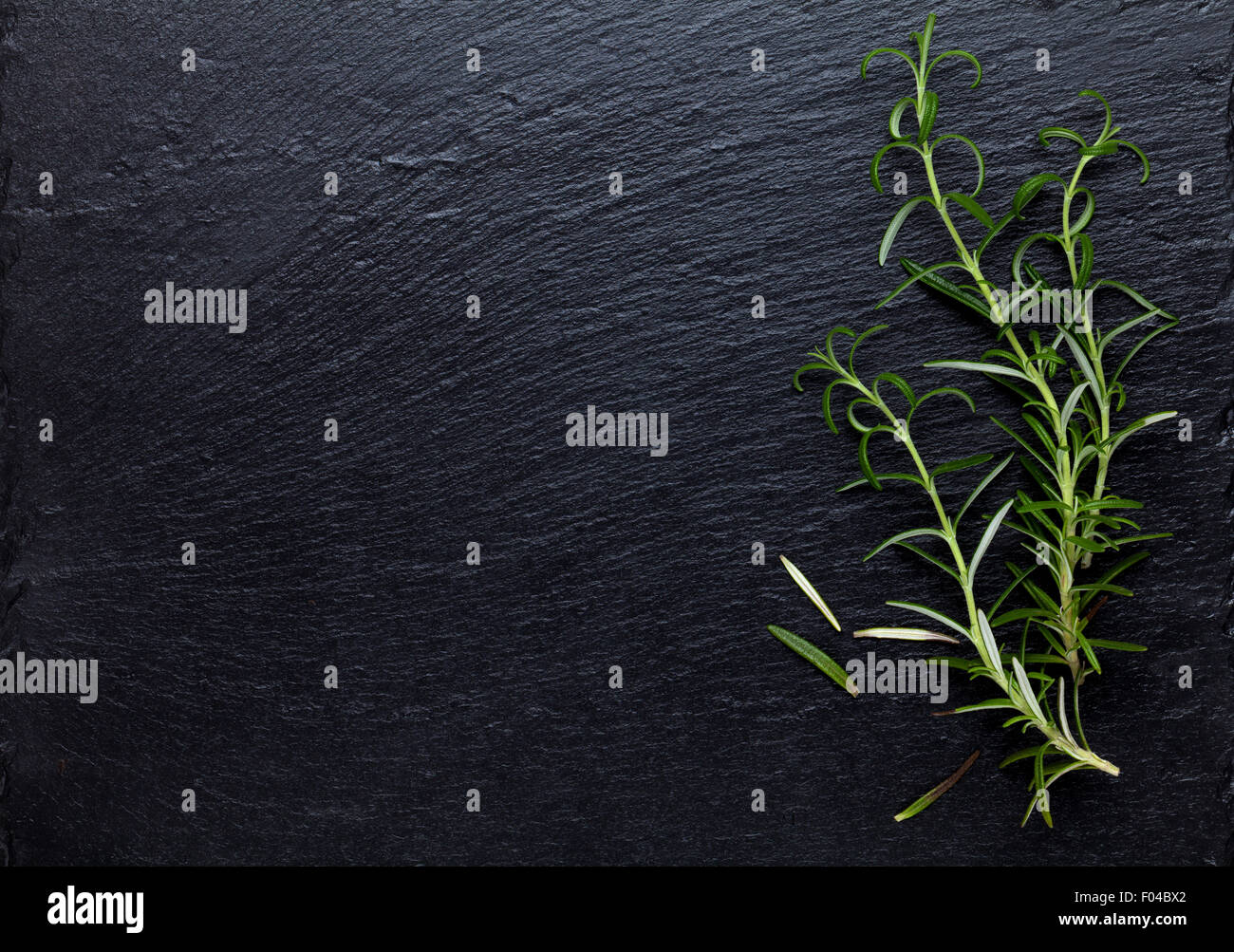 Rosemary herb on stone table. Top view with copy space Stock Photo - Alamy