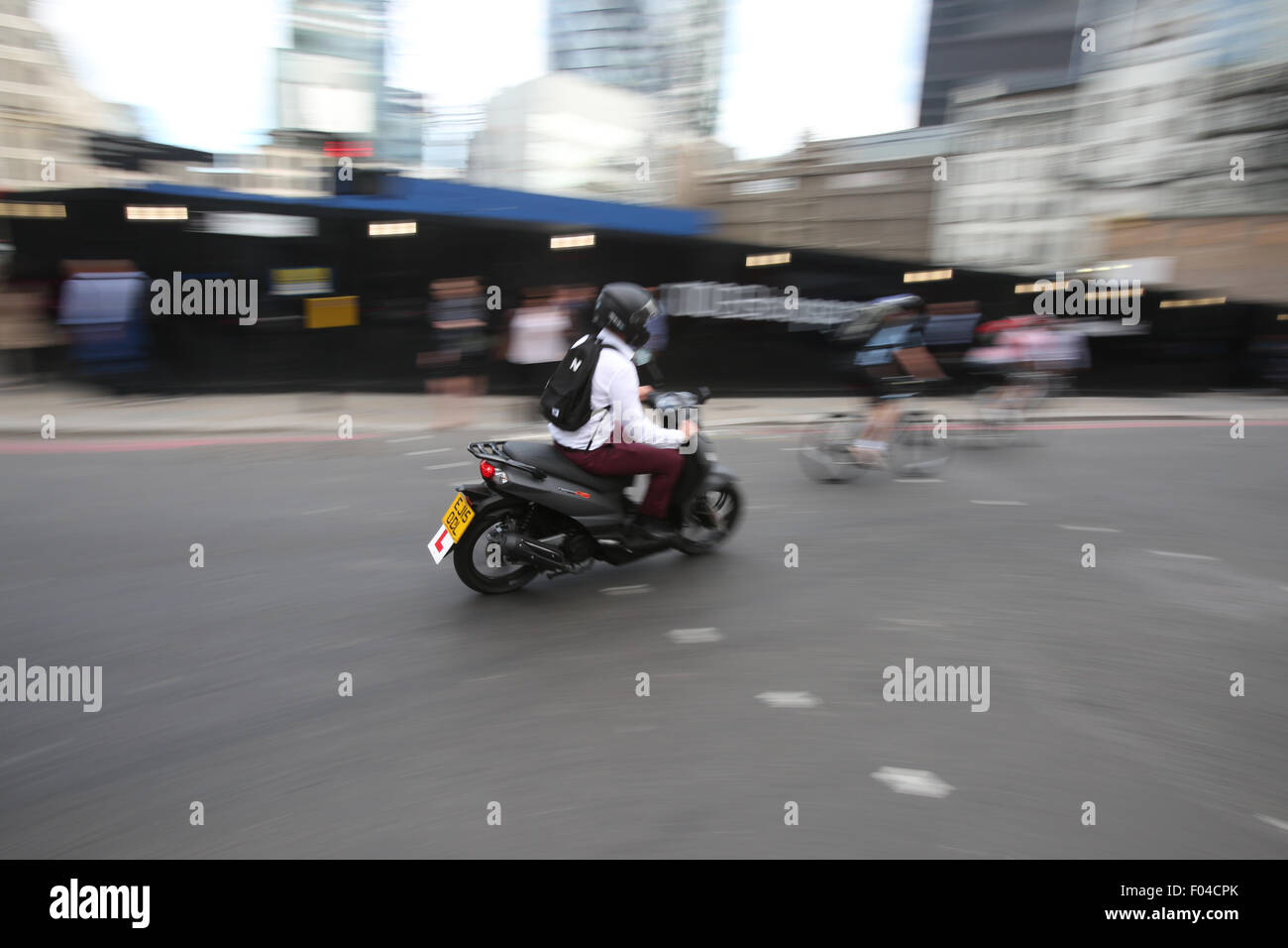 London, UK. 6th Aug, 2015. Moped rider at a busy interchange in Central ...