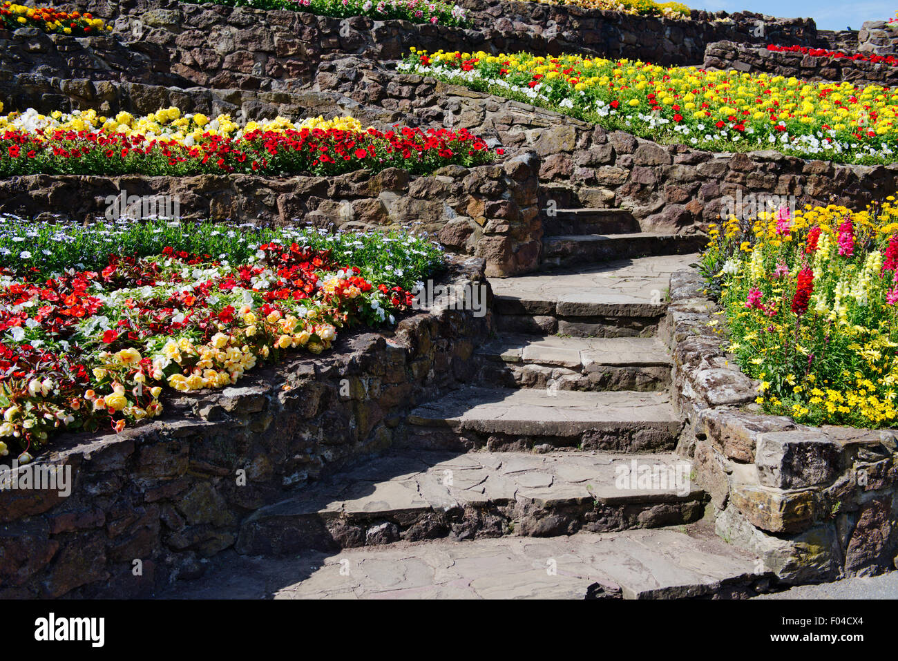 Stone steps, walls on terraced flower garden Stock Photo - Alamy