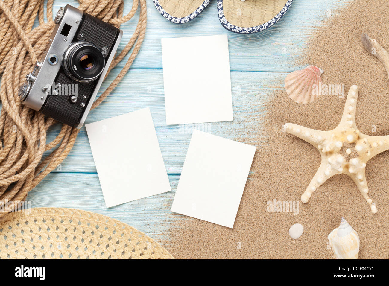 Travel and vacation photo frames and items on wooden table. Top view ...