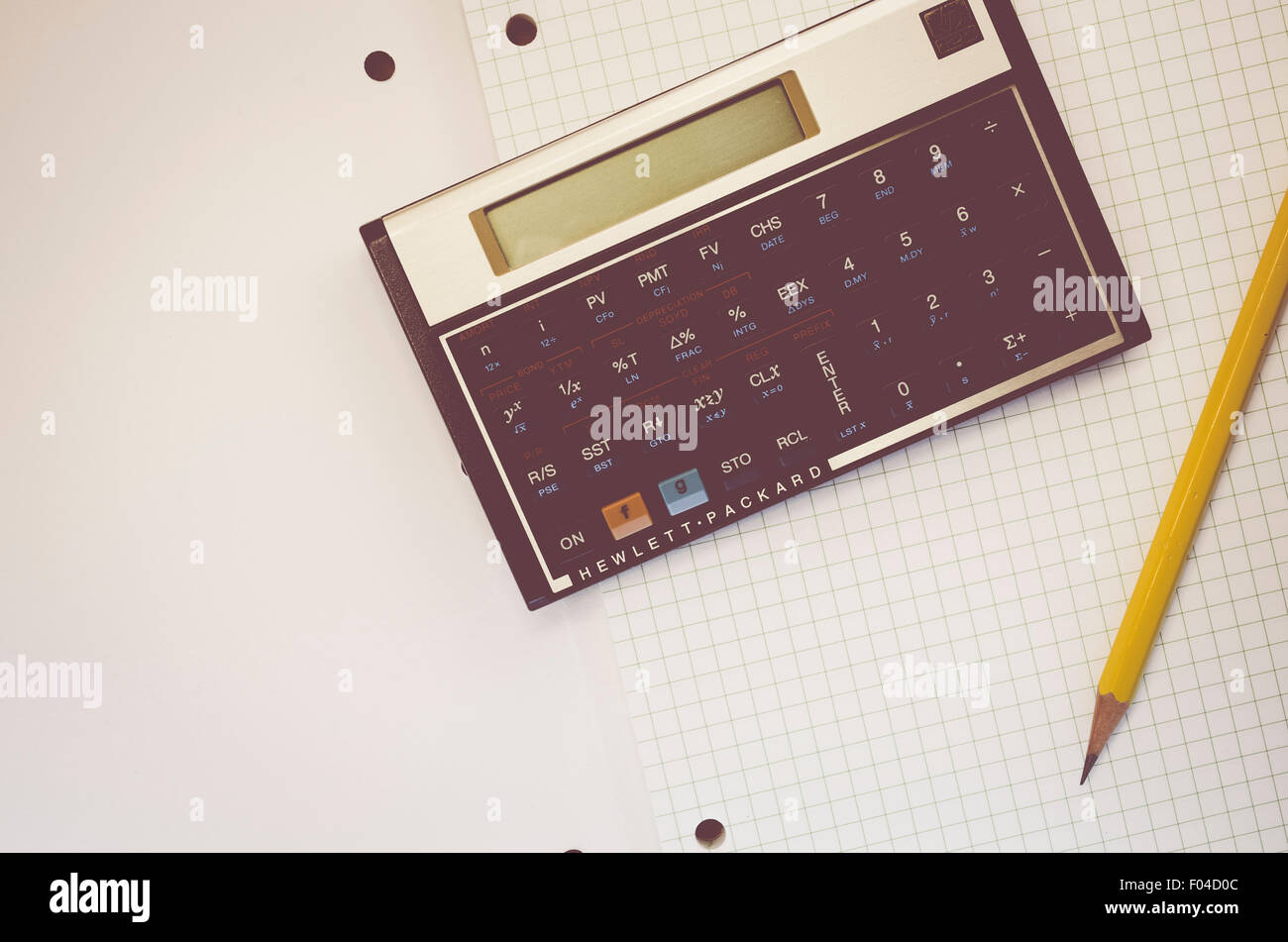 HP-12C Hewlett-Packard rpn finacial calculator and yellow pencil on a ...