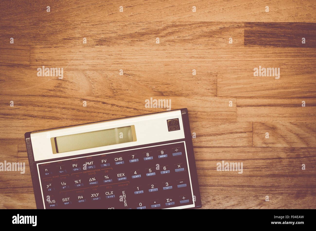 HP-12C Hewlett-Packard rpn financial calculator on a natural wood table ...