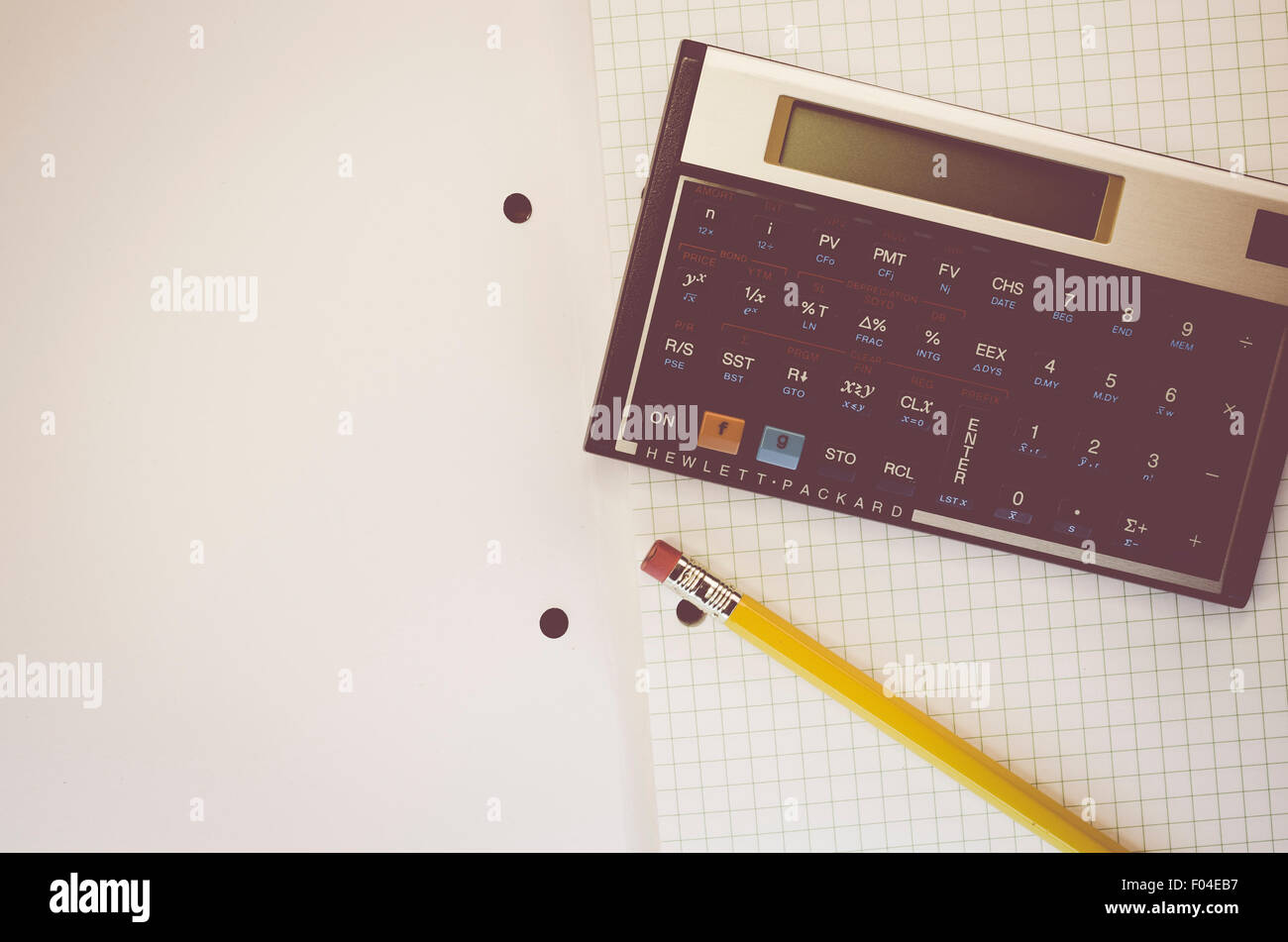 HP-12C Hewlett-Packard rpn financial calculator and yellow pencil on a ...