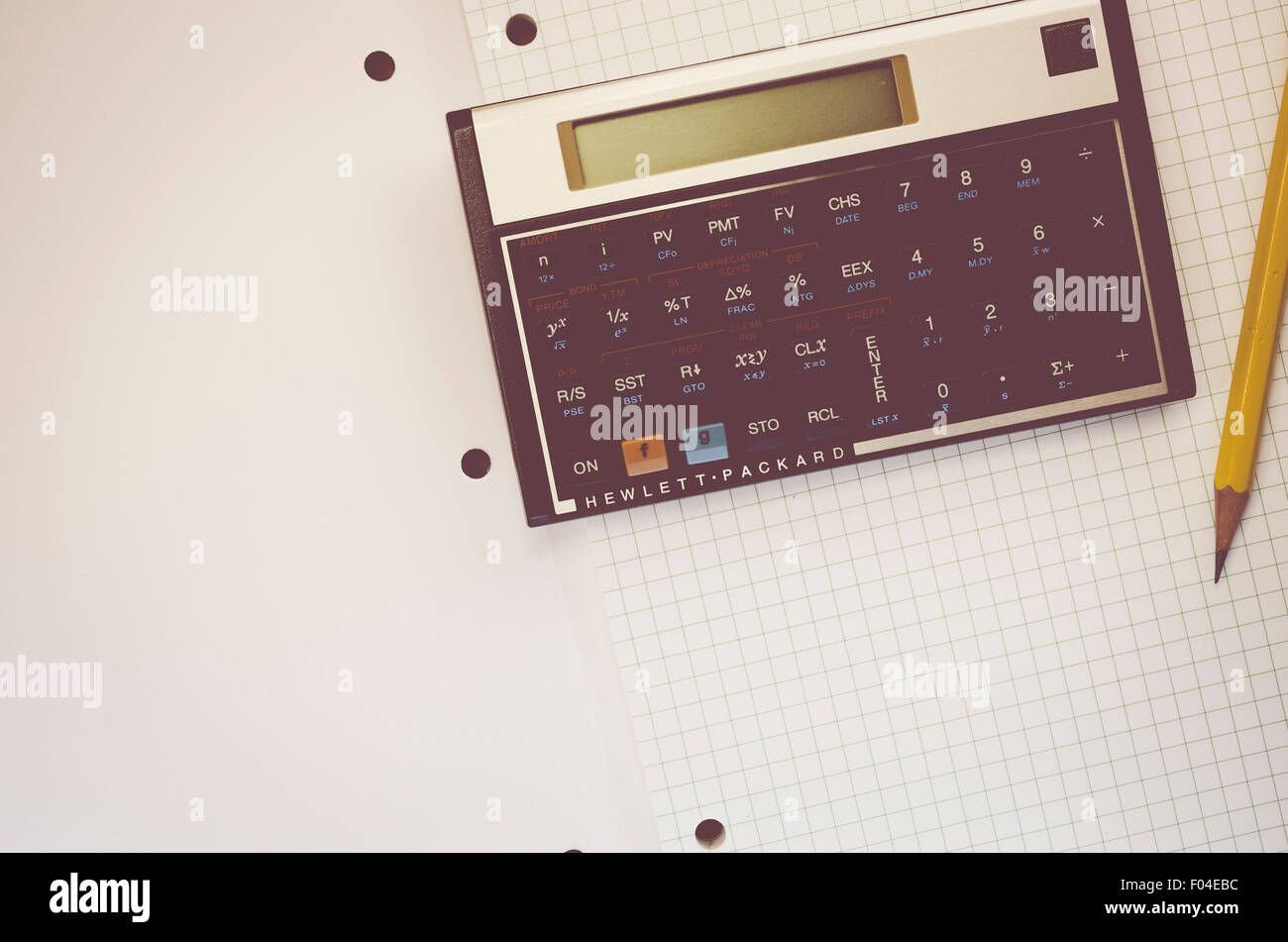 HP-12C Hewlett-Packard rpn financial calculator and yellow pencil on a ...