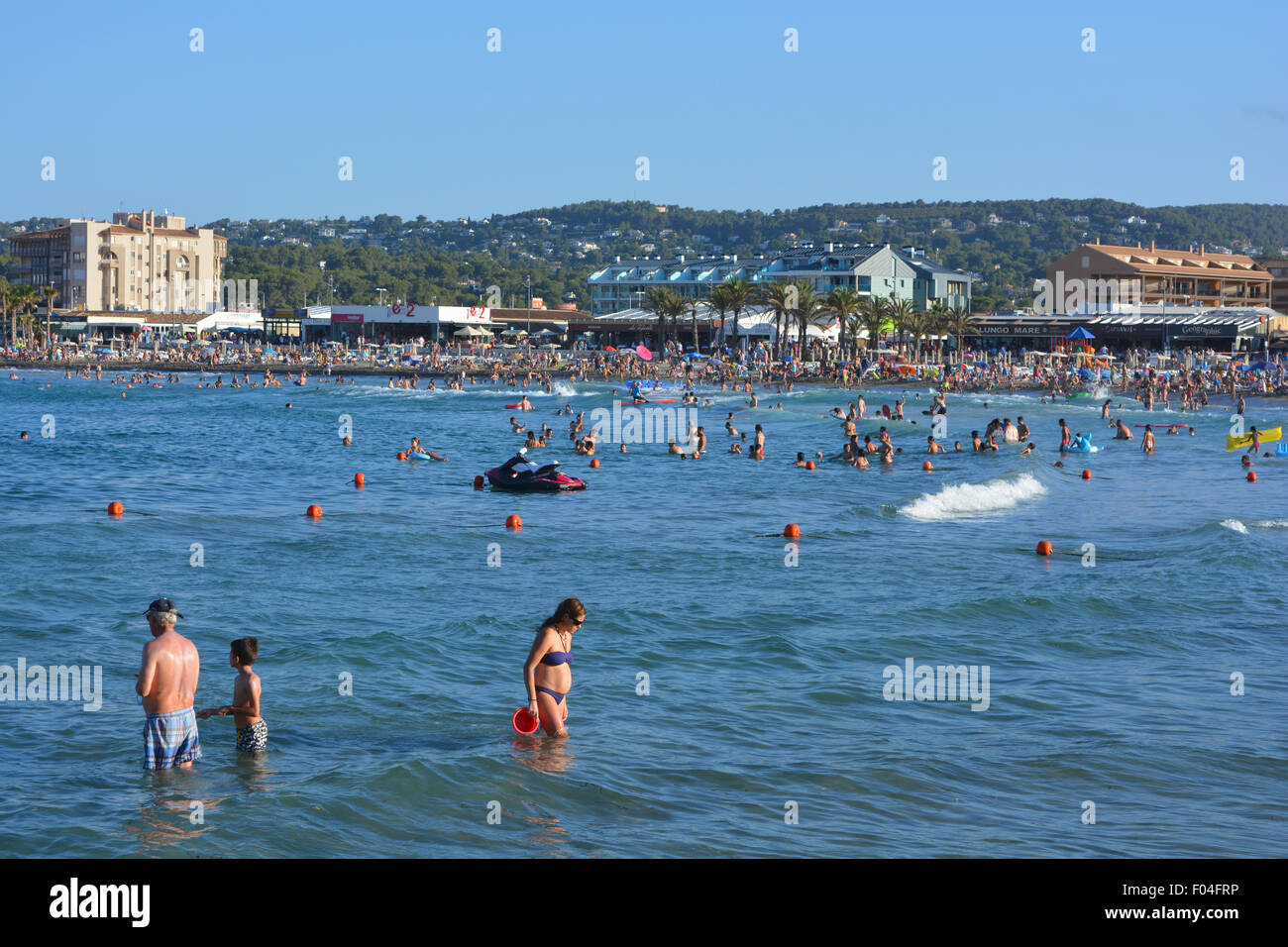 View to the Arenal beach in Javea on the Costa Blanca. Summer crowds ...