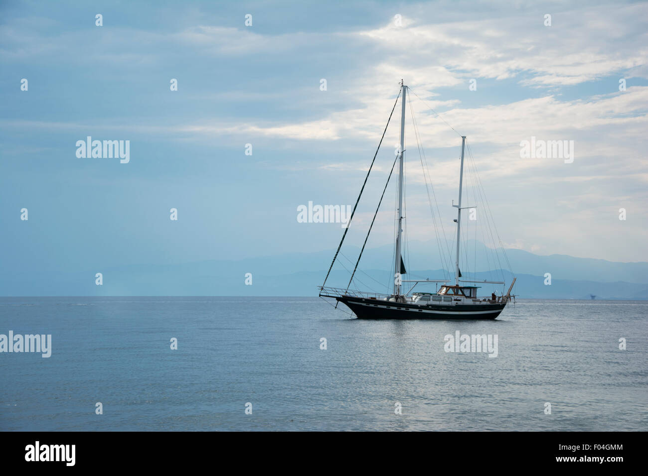 Beautiful boat alone in the blue sea Stock Photo - Alamy