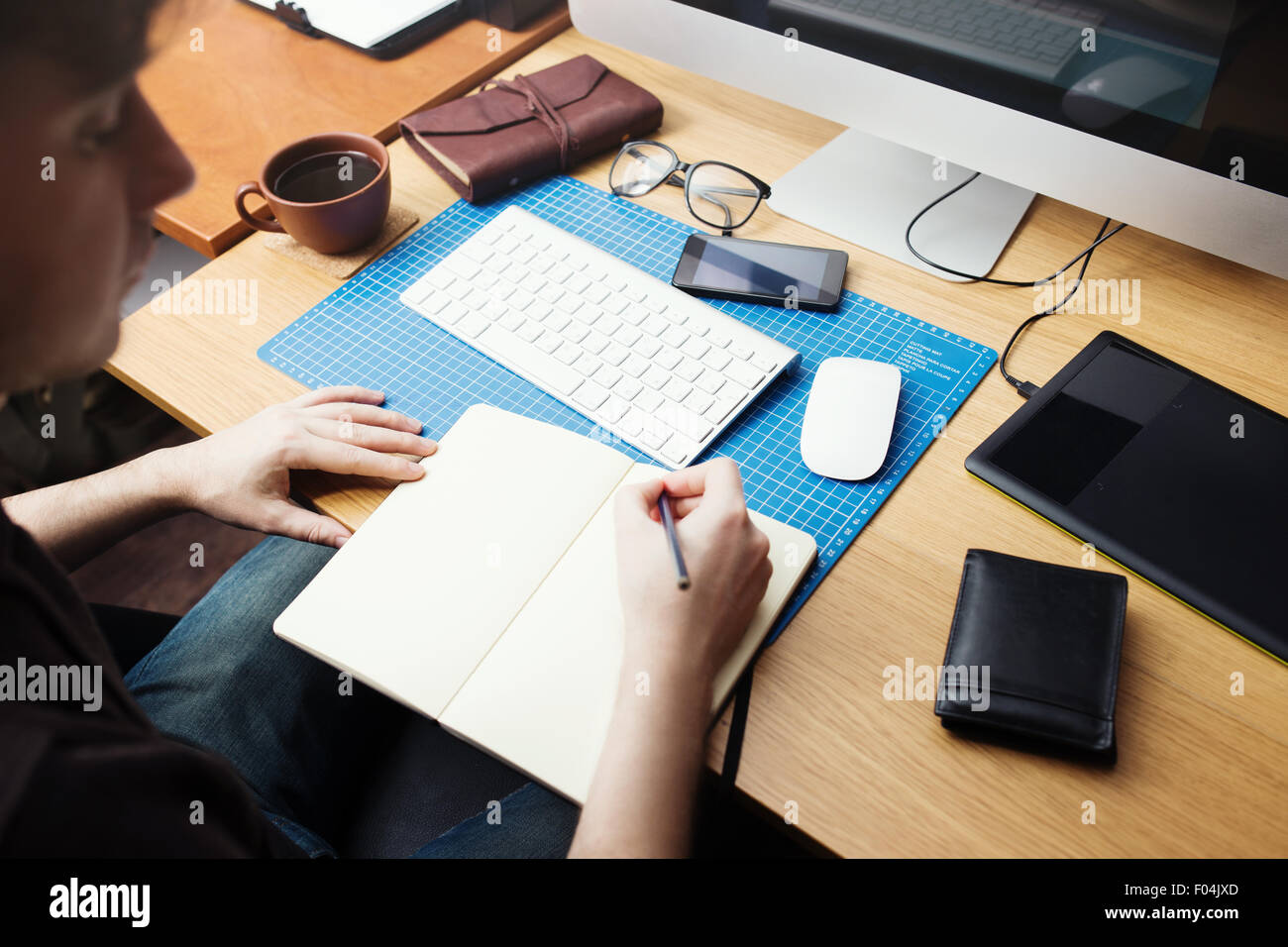 Freelance developer and designer working at home, man writing in ...